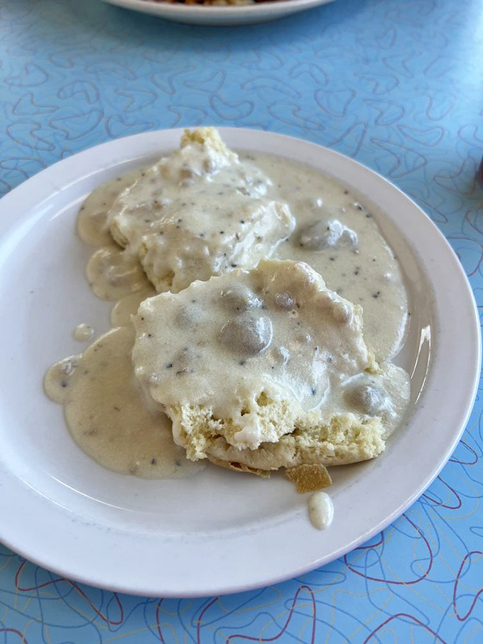 Southern comfort at its finest—fluffy biscuits swimming in creamy sausage gravy that could make even the most hardened breakfast critic weep with joy.