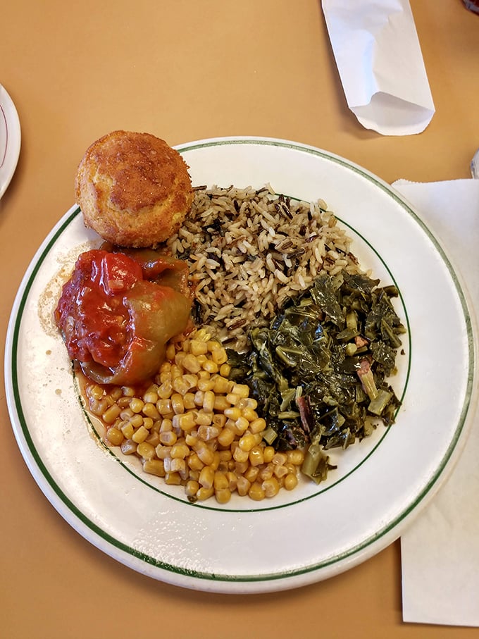 A Southern symphony on a plate – where collard greens, wild rice, and stuffed bell pepper perform a three-part harmony of comfort.