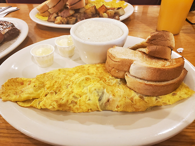 Classic breakfast perfection that reminds you why simplicity often trumps complexity—an omelet, home fries, and toast that hit all the right notes.