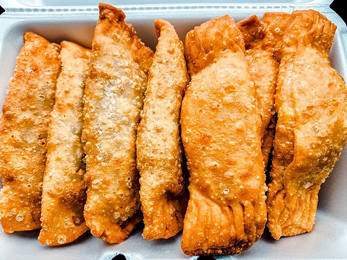 Golden-brown empanadas lined up like delicious soldiers ready for duty. Their mission? To make your taste buds surrender unconditionally.