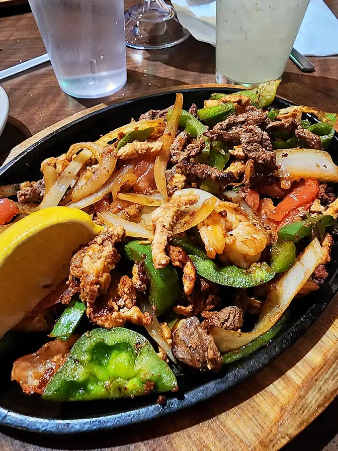 Sizzling fajitas that announce their arrival before you see them—like a delicious parade that ends at your table.
