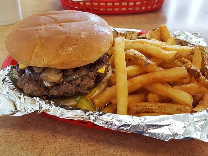 Golden fries nestled beside a burger that's clearly the star of the show—a dynamic duo of roadside perfection.