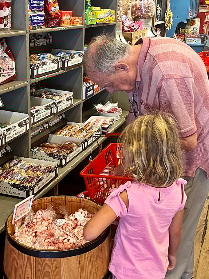 Intergenerational joy as grandfather and granddaughter share the universal language of candy selection – some traditions need no translation.