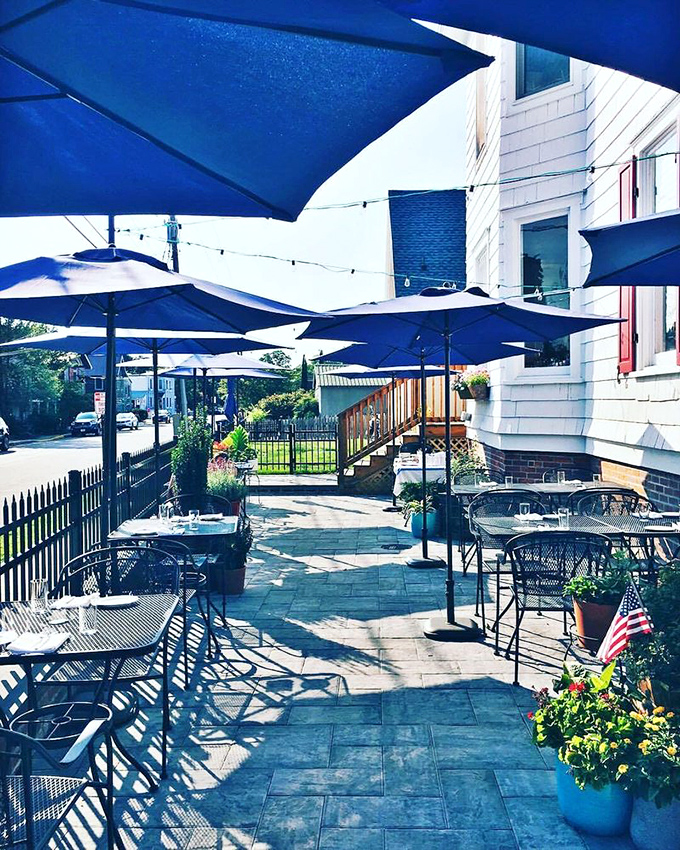 Heirloom's outdoor patio combines coastal charm with serious dining. Those blue umbrellas aren't just for show—they're sheltering taste sensations that might make you momentarily forget about the beach.