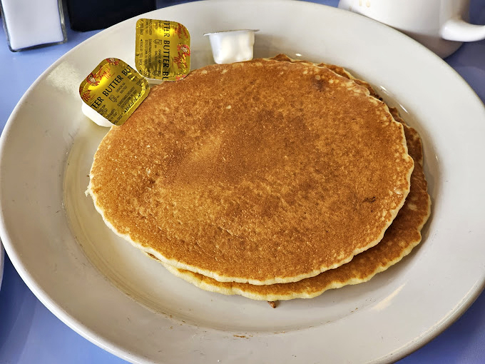 Pancakes so perfectly round they could double as frisbees—if you could bear to throw something this delicious.