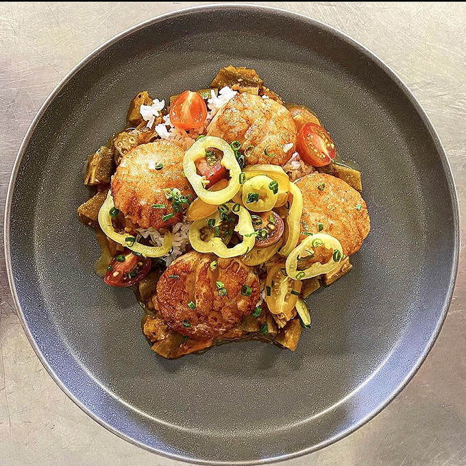 Golden-brown perfection meets artistic presentation. These aren't just scallops—they're little discs of oceanic bliss that somehow found their way to landlocked Indiana.