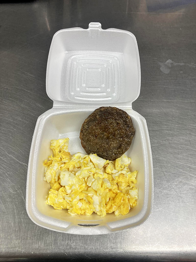 Breakfast of champions, Indiana-style. Golden scrambled eggs and a seasoned sausage patty—simple food done right beats fancy brunch any day of the week.