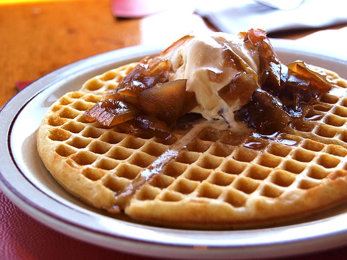 Waffle nirvana achieved! Golden ridges cradle caramelized apples while maple butter melts seductively into every perfect square. Worth every mountain mile driven.