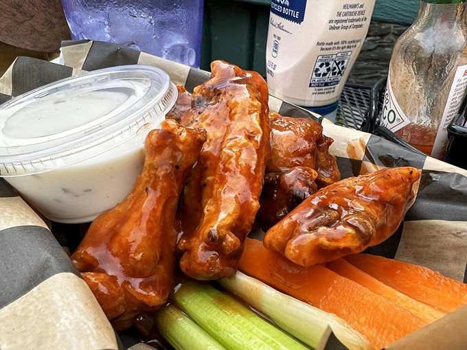 These wings aren't just taking flight—they're soaring with sauce and accompanied by the kind of dipping experience that requires an extra napkin or three.