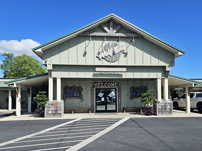 Wolf Bay's rustic wooden entrance says "Welcome" in a way that feels like a handshake from an old friend who happens to make killer hush puppies.