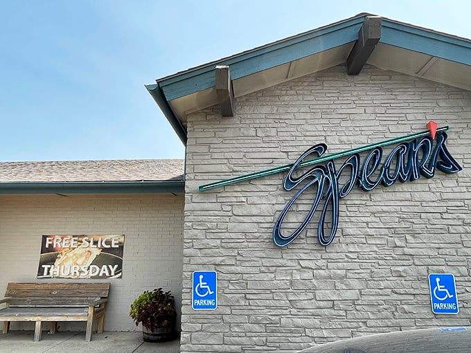 The stone facade at Spear's – where "Free Slice Thursday" might be the three most beautiful words in Kansas.