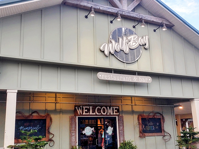 The understated elegance of Wolf Bay's wooden sign hints at what awaits inside—seafood that doesn't need to shout to get your attention.