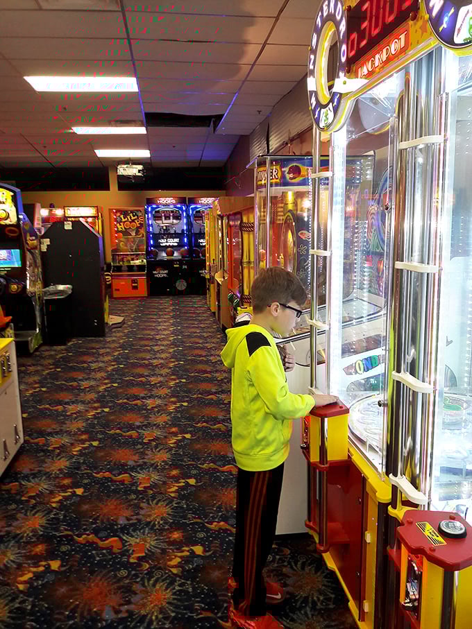 The arcade corridor—where allowances disappear faster than ice cream in August and kids develop the hand-eye coordination NASA should be recruiting.