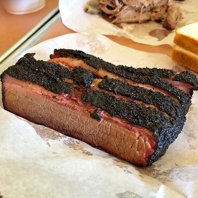 The bark on this brisket is the stuff of legend—peppery, crisp, mysterious. Inside, the meat remains as tender as a country love song.