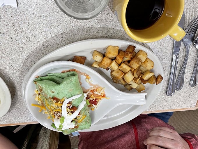 Behold the green-tinged wonder! This spinach tortilla burrito isn't just colorful—it's practically a vegetable serving wrapped around breakfast bliss.