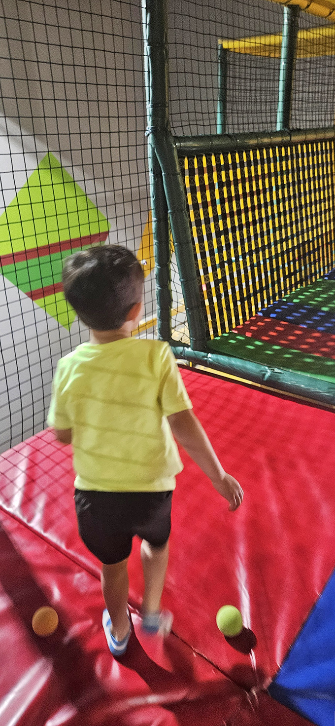 A youngster navigates the trampoline zone—that magical place where gravity takes a coffee break and kids burn limitless energy.