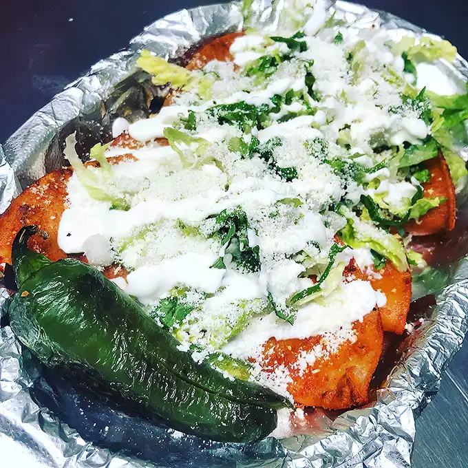 Red sauce, white cheese, green lettuce—it's the Mexican flag in edible form! Patriotism never tasted so good or disappeared so quickly.