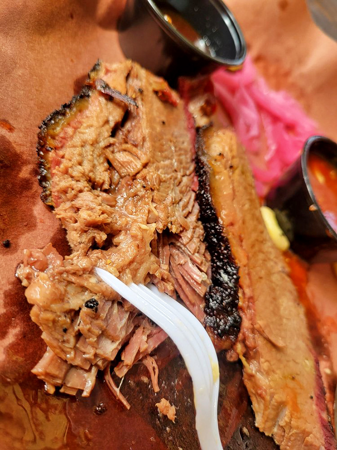 Behold the money shot—tender, juicy brisket with that signature pink smoke ring. This is what barbecue dreams are made of.