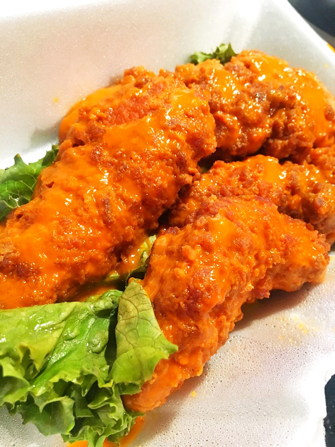 Buffalo tenders that glow with promise. That vibrant orange sauce isn't just showing off—it delivers heat and flavor in equal measure.