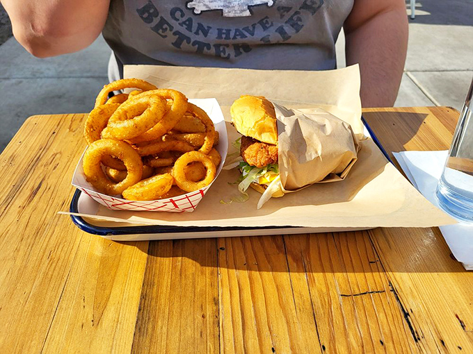 The classic American duo—crispy onion rings and a juicy burger. Name a more iconic partnership… I'll wait.