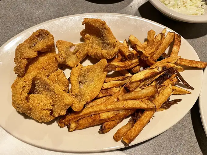 This isn't just catfish and fries—it's edible Arkansas heritage on a plate. The cornmeal crust crackles with each bite, revealing tender fish beneath.