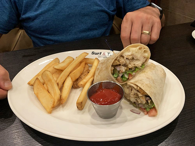 This chicken wrap with its golden fries sidekick is the lunch equivalent of finding money in your coat pocket—an unexpected joy that makes your day better.