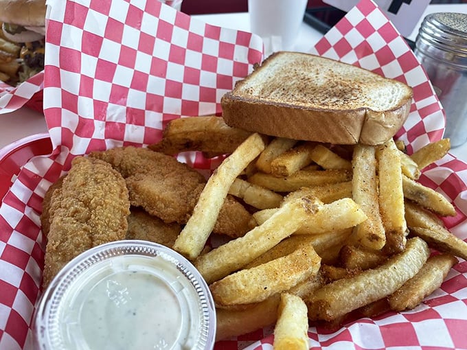 Chicken tenders that actually deserve the name "tender," with fries that could make a Frenchman weep with joy. Simple perfection on a red basket.