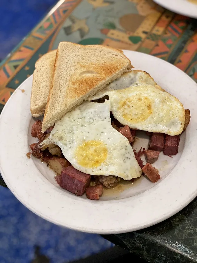 Corned beef hash crowned with perfectly fried eggs – the breakfast equivalent of finding an extra $20 in your winter coat pocket.