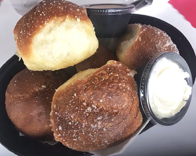 These golden-brown dinner rolls aren't just bread – they're warm, pillowy vehicles for the butter that melts into their souls.