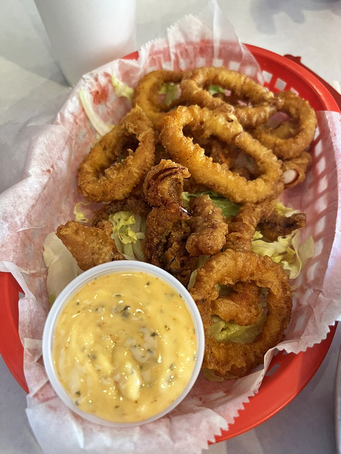 These crispy calamari rings deserve their own Olympic event. The creamy dipping sauce gets the silver medal—it knows its place.