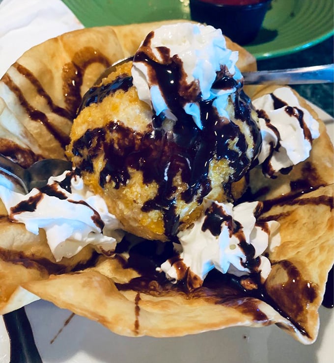 Fried ice cream arrives like a delicious contradiction—hot, crispy shell giving way to cool, creamy center with chocolate sauce creating flavor fireworks.