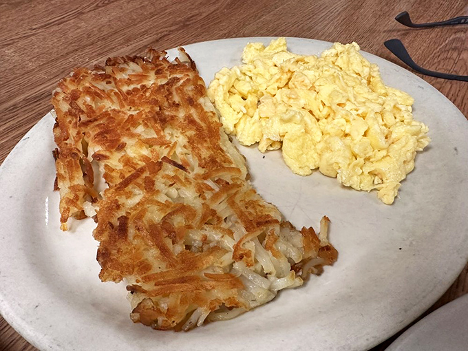 Those hash browns deserve their own fan club—crispy exterior, tender inside. Paired with eggs that somehow look exactly like the ones in your breakfast dreams.