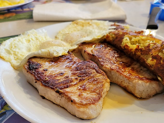 These pork chops aren't just cooked—they're respected. Perfectly seared with eggs sunny-side up, proving breakfast doesn't have to be delicate to be delicious.