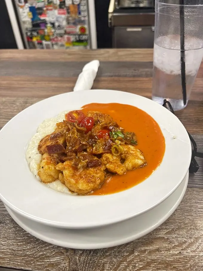These shrimp and grits aren't just a dish—they're a Southern baptism. That tomato gravy could make a grown person weep with joy.