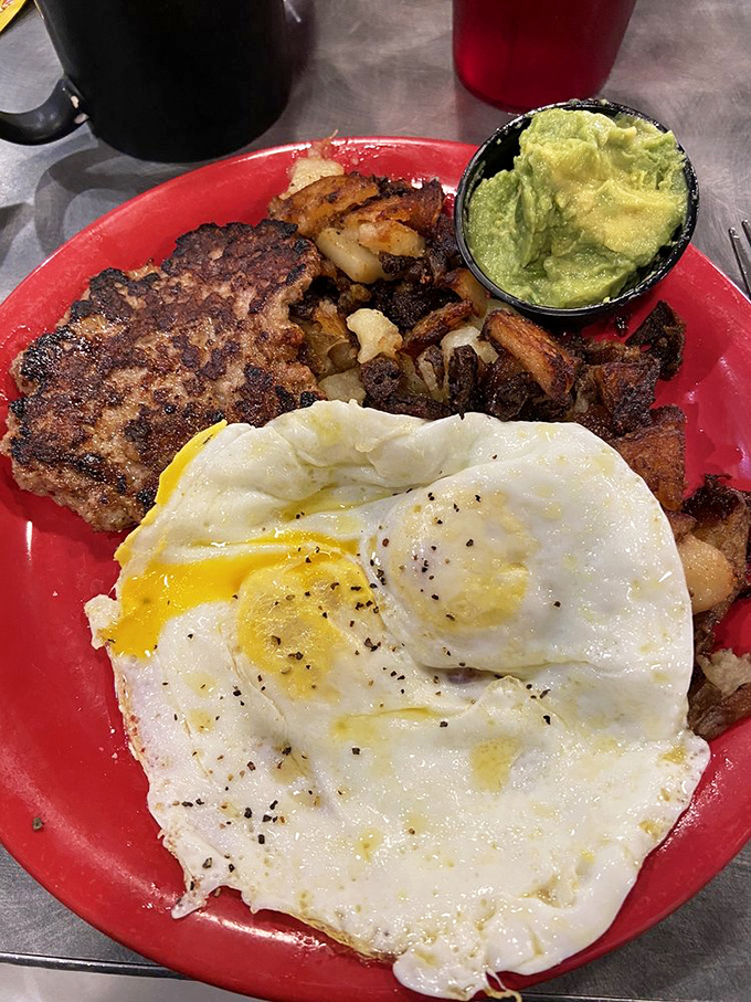 A breakfast plate that demands your full attention—perfectly fried eggs with golden yolks ready to create nature's most perfect sauce for those crispy potatoes.