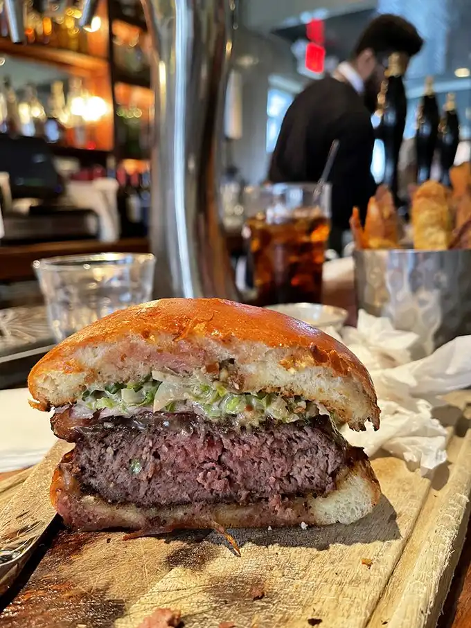 This burger isn't just a meal, it's a revelation—medium-rare perfection peeking through a toasted bun with the kind of structural integrity that prevents the dreaded mid-bite collapse.