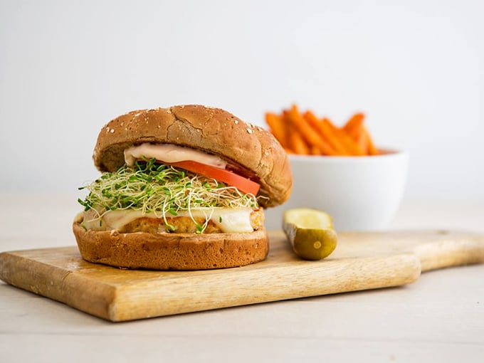 Even in a temple of meat, plant-based options shine. This veggie burger with sprouts isn't an apology—it's a declaration that vegetarians deserve joy too.