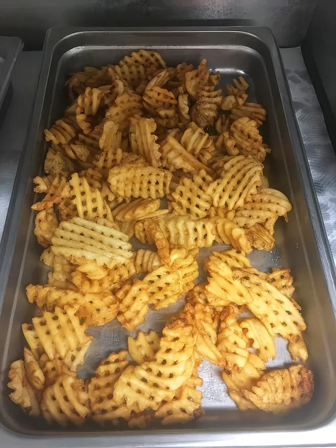Not just any fries – these waffle-cut beauties have the perfect ratio of crispy exterior to fluffy potato interior. A textural masterpiece.