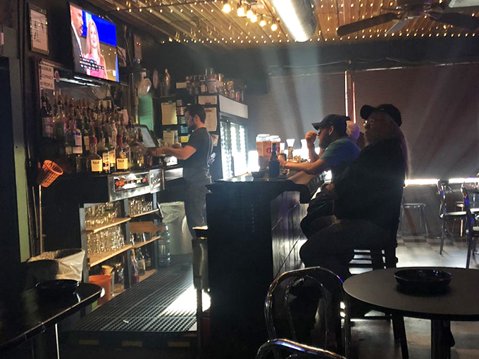 In the glow of neon and TV screens, strangers become friends and regulars become family—the universal alchemy of a great neighborhood bar.