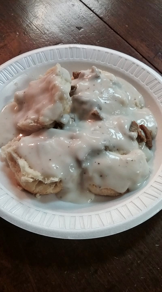 Biscuits swimming in creamy sausage gravy—the kind of breakfast that requires a nap afterward and makes you wonder why anyone bothers with avocado toast.