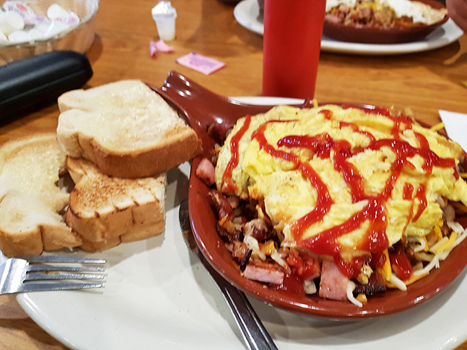 This breakfast skillet doesn't just satisfy hunger—it abolishes it, with eggs, potatoes, and toppings playing a harmonious morning symphony on your plate.