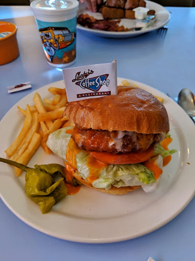 A burger that requires both hands and a strategy. That little flag isn't decoration—it's claiming territory in the name of flavor.
