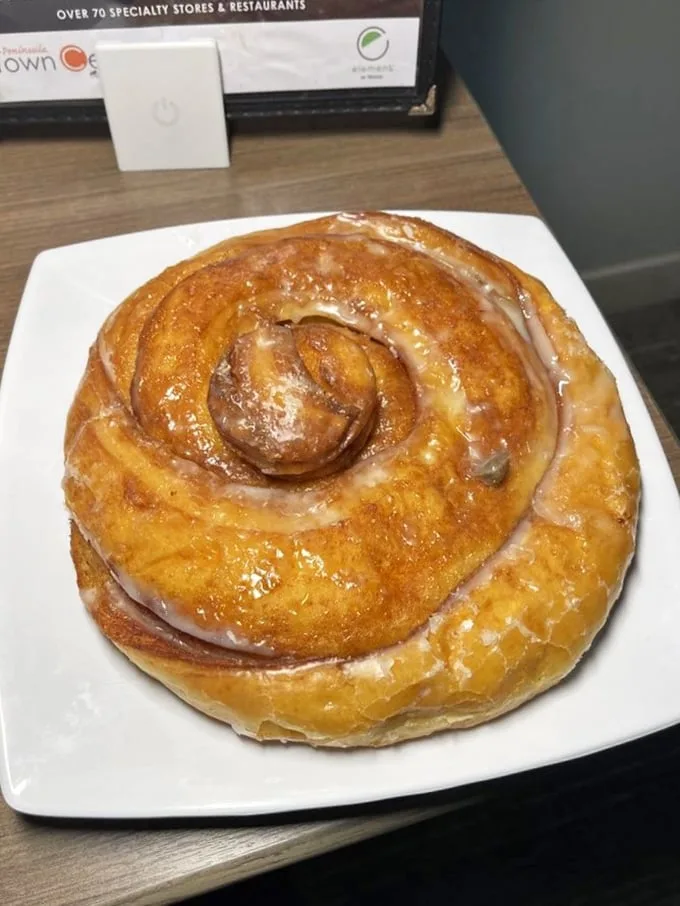 This cinnamon roll isn't playing around—it's a spiral galaxy of buttery dough and spice that demands to be the center of attention.