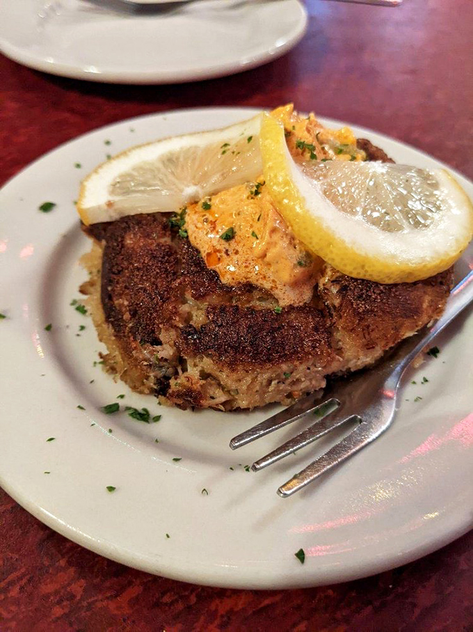 The crab cake arrives with lemon slices standing at attention, as if they know they're in the presence of seafood royalty.