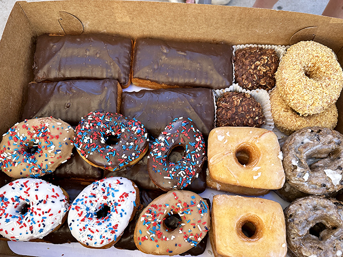 A dozen donuts in a box—the universal language of "I like you enough to share calories." Each one a different personality.
