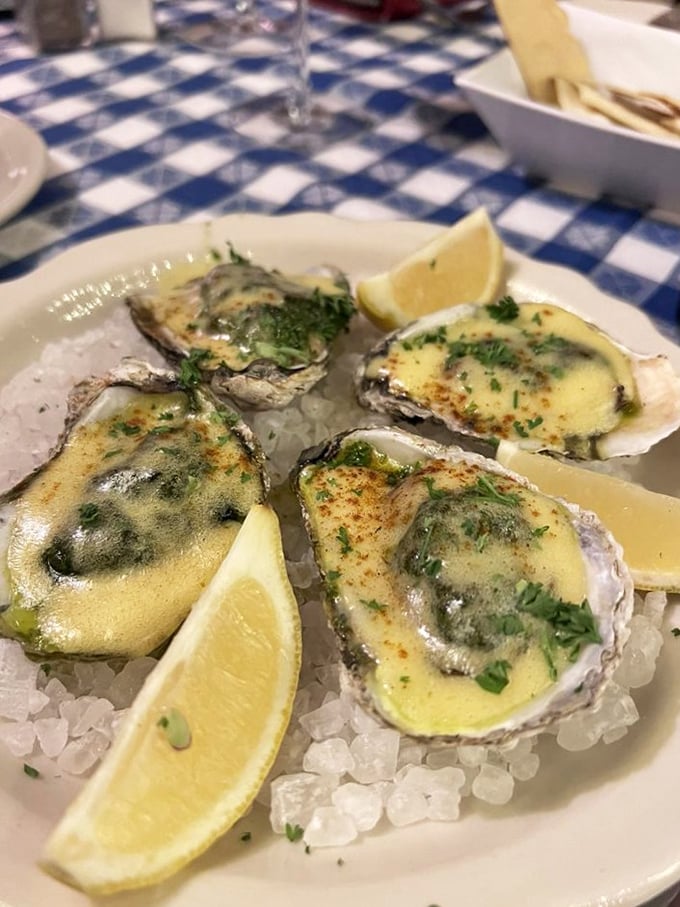 Oysters on ice—nature's perfect appetizer. Topped with a buttery sauce, they're like little ocean treasures in formal wear.