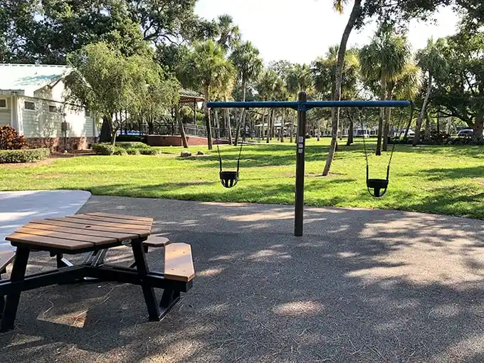 A playground and picnic area where kids can swing while parents recover from vacation-induced ice cream headaches. Florida greenspace at its most inviting.