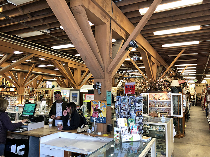 The exposed beam architecture isn't just structural—it's skeletal poetry from Monterey's industrial past, now supporting a marketplace of memories instead of machinery.