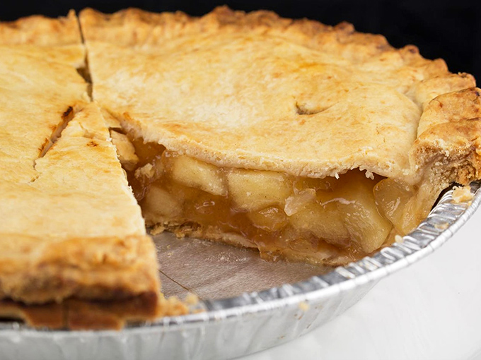 One slice missing reveals the golden secret within—perfectly cooked apples suspended in their own caramelized juices. Resistance is futile.