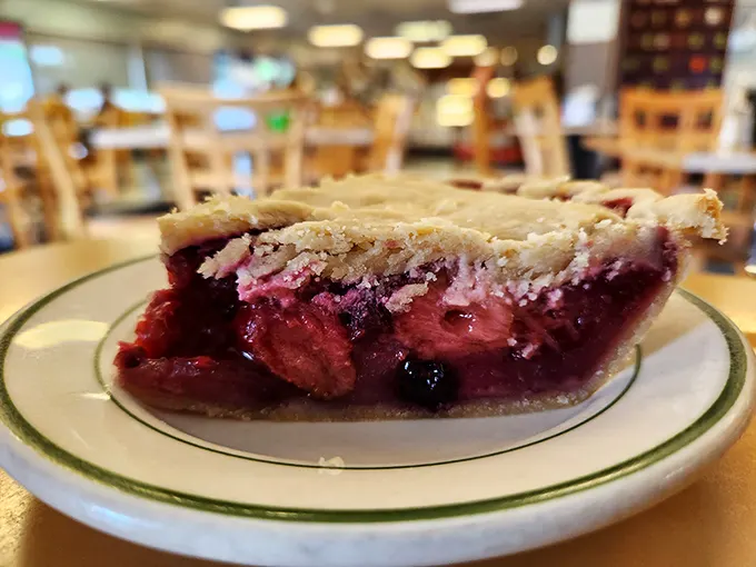 This isn't just berry pie – it's edible art with a perfectly flaky crust that shatters just right when your fork makes its eager descent.